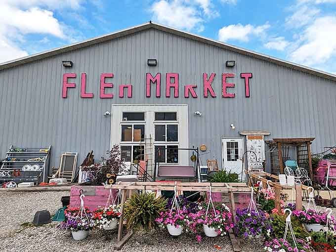 The pink lettering on this gray barn promises treasures within &ndash; Me & My Sisters Flea Market welcomes bargain hunters with floral flair!