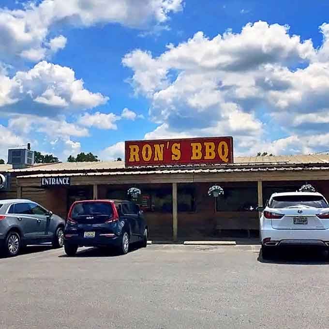 That classic roadside BBQ look with the big sign means serious smoke and flavor wait inside for you.