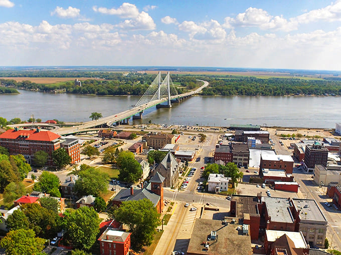 The mighty Mississippi River bridge spans like a gateway to affordable living dreams in Iowa.