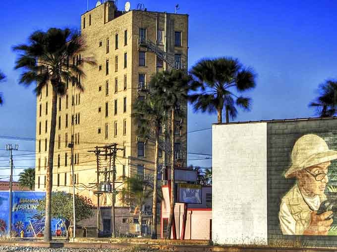 This historic Baxter Building stands tall among palm trees, a nine-story reminder that South Texas has stories worth telling.