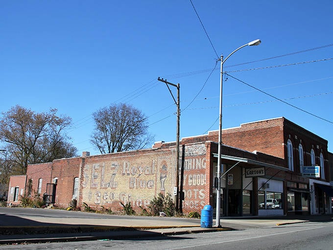 White Hall's downtown stretches into the distance under clear blue skies. The wide main street offers plenty of parking for leisurely shopping.