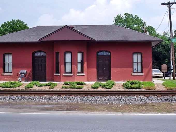 This historic red brick building in Wyoming tells stories of simpler times, standing proudly alongside railroad tracks that shaped the town.