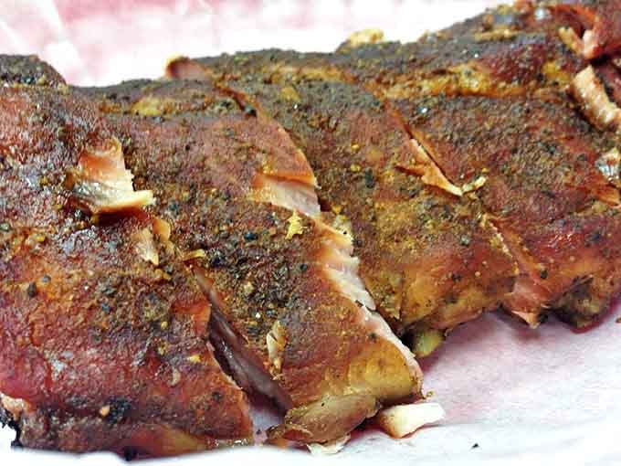 Ribs with a bark so perfect you'll want to frame it. The spice rub creates a crust that's practically a religious experience.