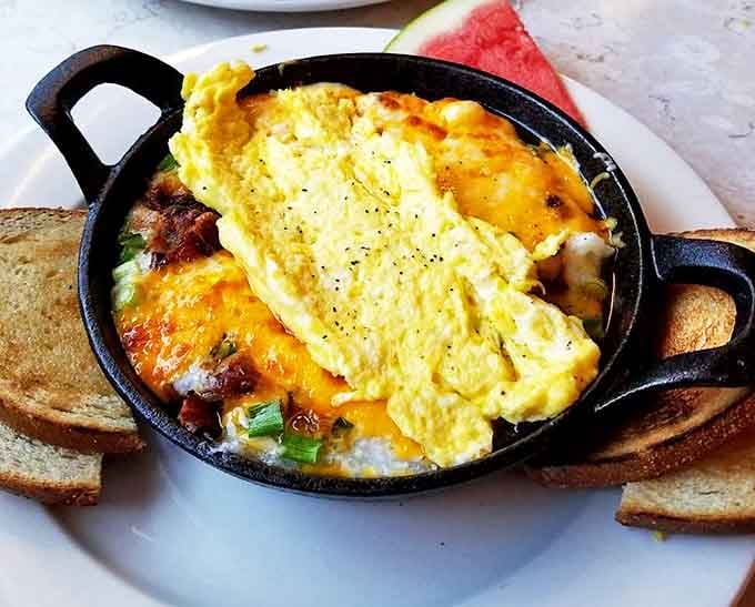 This skillet of cheesy eggs isn't just breakfast&mdash;it's edible sunshine with a side of perfectly toasted bread. Morning glory on a plate.