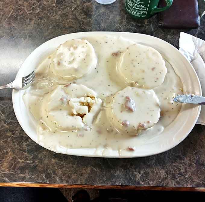 These biscuits and gravy aren't just a side—they're the main event. Four pillowy islands floating in a sea of peppery sausage gravy.