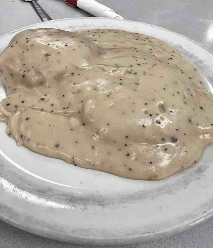 Not all heroes wear capes; some ladle gravy this good. This cloud of peppery comfort is what breakfast fantasies are made of.