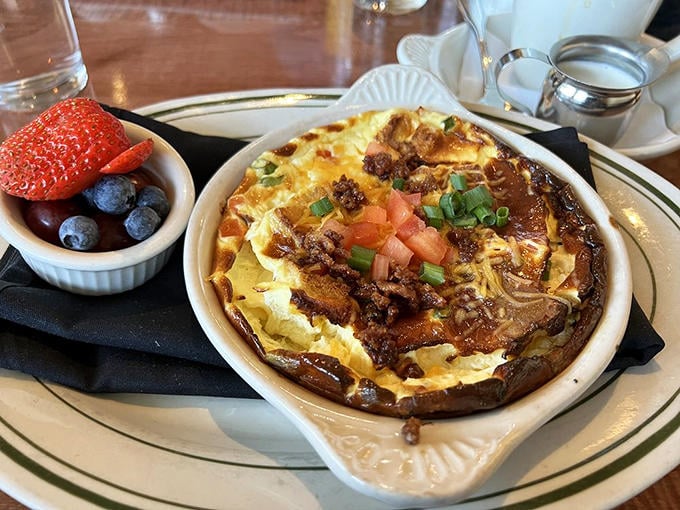 The Breakfast Strata arrives like edible architecture&mdash;layers of flavor with a side of berries that somehow makes it virtuous.