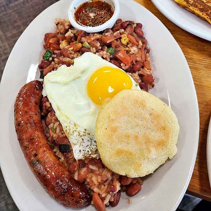 This isn't just breakfast&mdash;it's a vacation on a plate. Sausage, beans, rice, and a perfectly fried egg create a symphony of flavors that'll make your taste buds applaud.