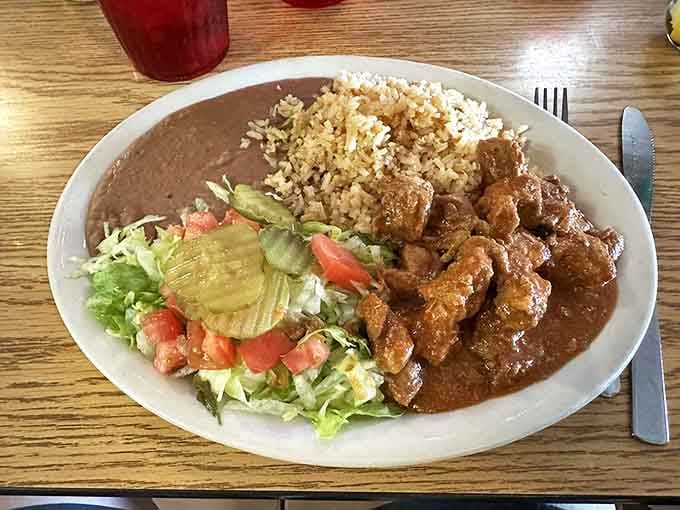 Carne guisada that doesn't need a filter&mdash;tender beef swimming in gravy that would make your grandmother weep with joy, served with the holy trinity of rice, beans, and salad.