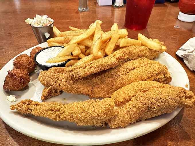 Golden-brown catfish that would make a fish-avoider reconsider their life choices. The cornmeal crust creates that perfect crunch that echoes through your memory for days.