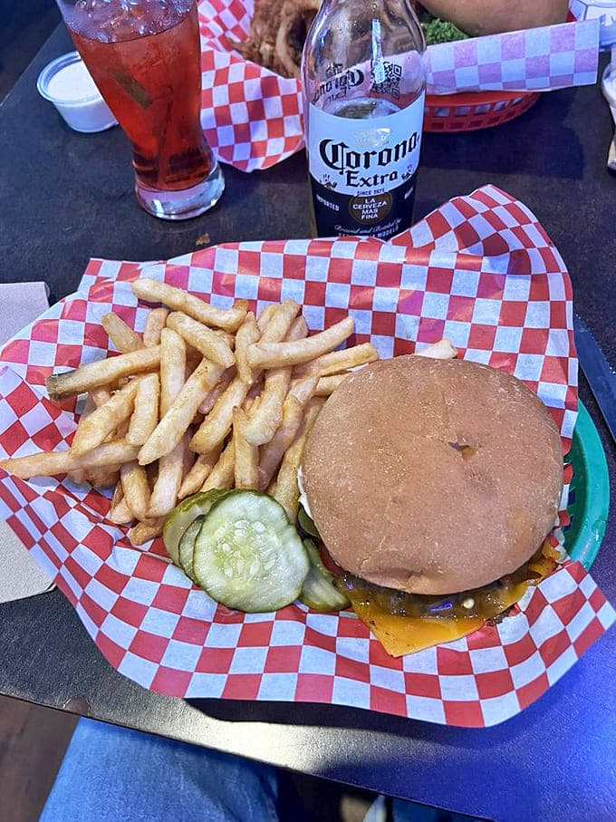 The classic burger-fries-beer trinity, elevated to art form. That pickle slice isn't garnish&mdash;it's the exclamation point on a delicious sentence.