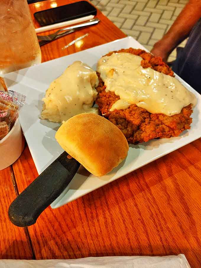Chicken fried steak swimming in creamy gravy with a side of mashed potatoes&mdash;Southern comfort that hugs your soul before it fills your stomach.