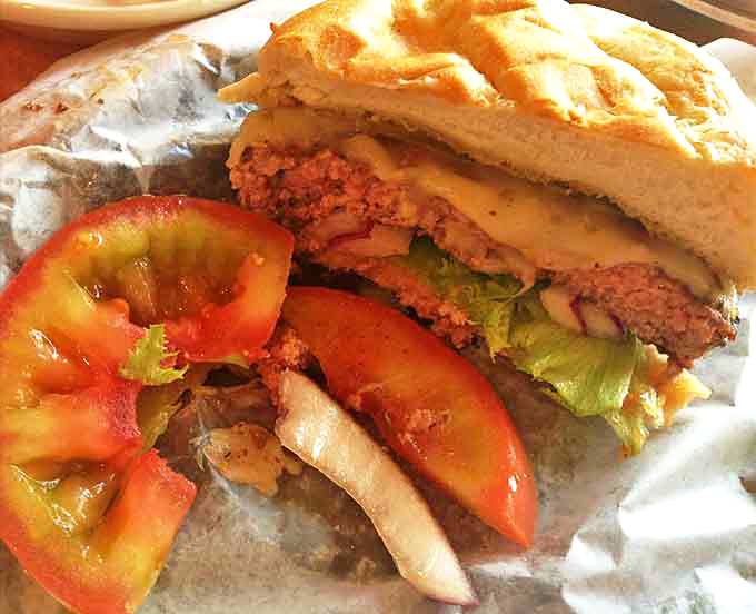 This isn't just a burger—it's architecture. Layers of fresh tomato, crisp lettuce, and juicy beef create a sandwich skyline worthy of its own postcard.