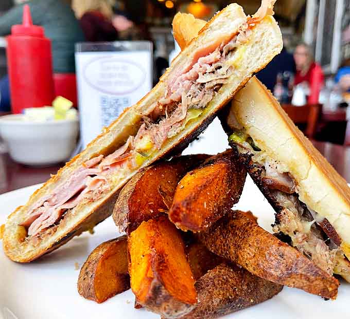 This isn't just a sandwich; it's architecture. Layers of ham and pork with perfectly golden potato wedges&mdash;a Cuban masterpiece worthy of its own passport.