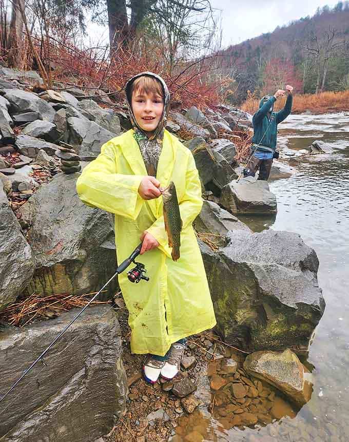 The pure delight of a successful catch! This young angler's expression says everything about the timeless joy of fishing in Pennsylvania's pristine waters.