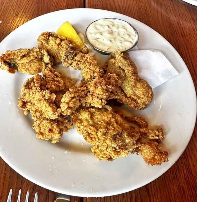 Golden-crusted fried delights that shatter with each bite, paired with a creamy dip that whispers, "Y'all come back now."