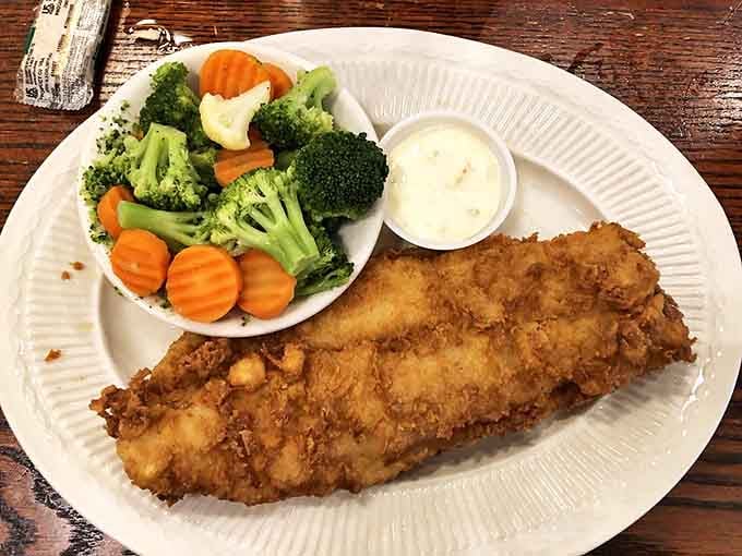 Golden-fried catfish that would make Mark Twain weep with joy, paired with fresh veggies for those who appreciate the art of balance.