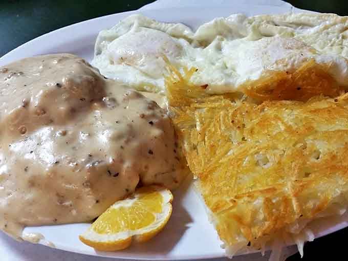 Biscuits and gravy with hash browns that glow like sunrise gold—comfort food that hugs you from the inside out.