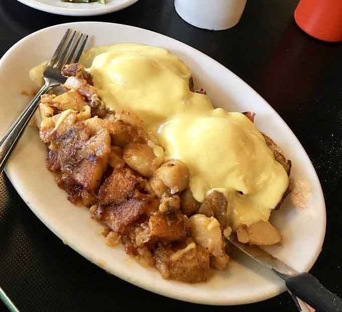 This isn't just breakfast&mdash;it's architecture. Home fries supporting eggs Benedict like delicious scaffolding beneath a canopy of hollandaise.