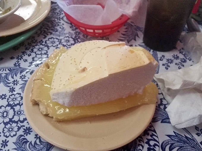 A slice of lemon meringue pie so tall and proud it deserves its own zip code. Cloud-like meringue meets tangy sunshine below.