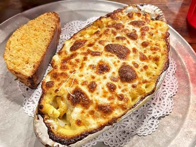 Mac and cheese that's achieved enlightenment—bubbling, golden-brown perfection that would make even the most hardened cowboy weep with joy.