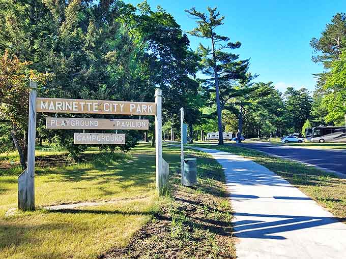 The entrance to Marinette City Park promises simple pleasures increasingly hard to find: shade trees, open spaces, and recreation without membership fees.