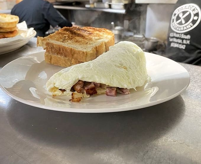 This omelet doesn't just fold eggs around fillings &ndash; it embraces them in a fluffy hug that makes ham and cheese feel special again.