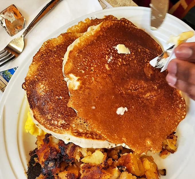 Golden-brown pancakes with a side of home fries that could make a potato farmer weep with joy. Breakfast perfection exists!