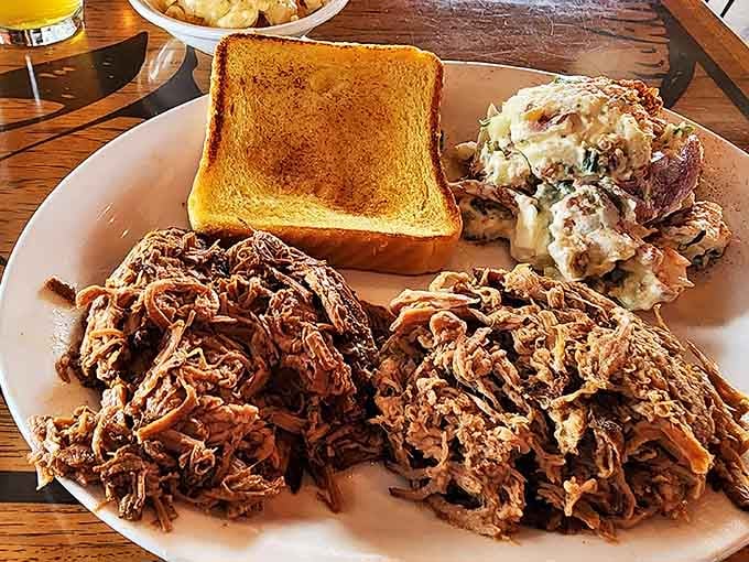 Pulled pork that looks like it's been teased apart by angels. This mountain of meat alongside creamy sides is the comfort food your soul has been craving.