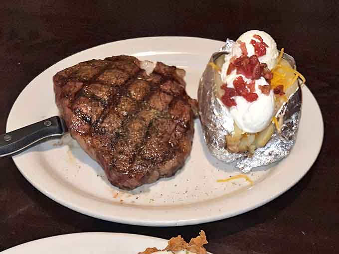 This ribeye isn't just a steak&mdash;it's a declaration of independence from mediocre meals, with a loaded potato as its faithful sidekick.
