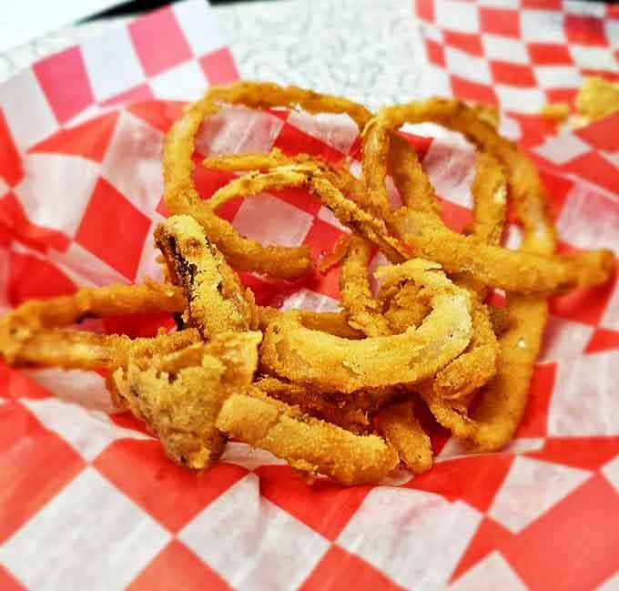 Golden halos of happiness. These onion rings aren't just fried—they're transformed into crispy, delicate treasures worth fighting over.