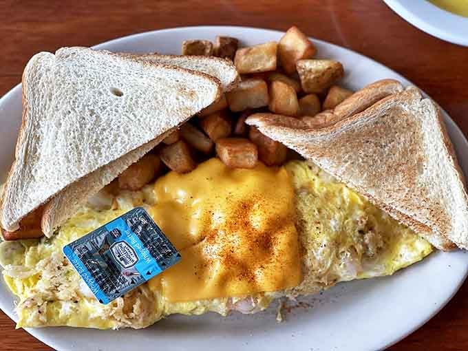 Breakfast architecture at its finest. When cheese meets eggs meets toast, with those perfectly golden home fries standing guard on the side.