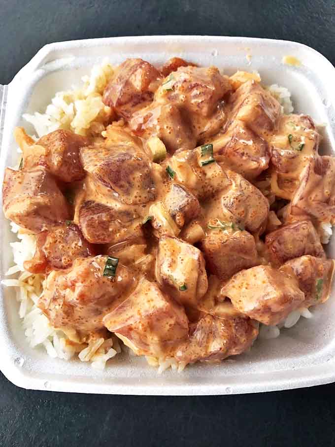 The spicy ahi poke bowl glistens with promise, each chunk of tuna bathed in a creamy, spice-laden sauce that'll make you forget your name.