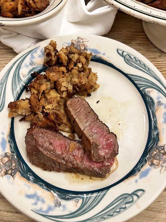 Perfectly pink porterhouse paired with those crispy German potatoes – a duo more iconic than Sinatra and New York, New York.