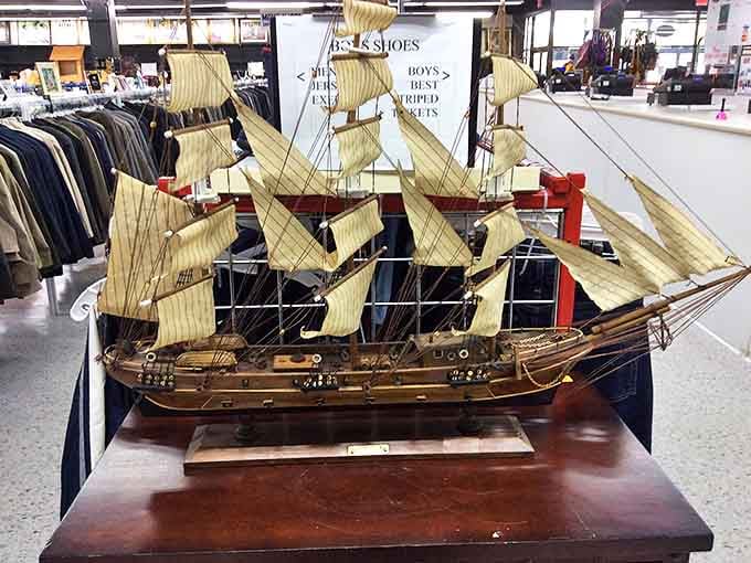Ahoy, treasure hunters! This model ship sails proudly among the clothing racks, a perfect example of the unexpected maritime marvels awaiting discovery.