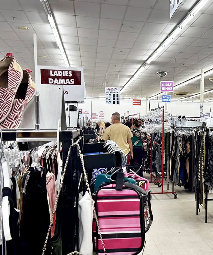 Department store organization meets yard sale prices. The women's section is a fashion time capsule where yesterday's trends await their inevitable comeback.