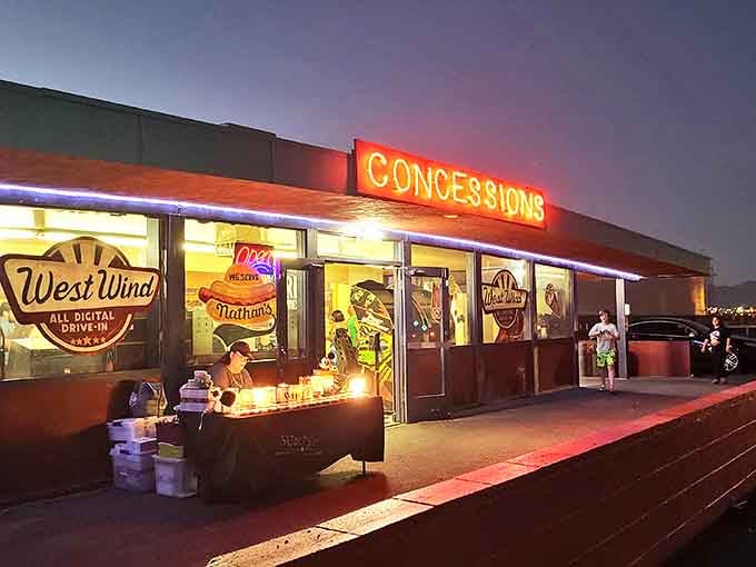 The concession stand's neon glow beckons with promises of buttery popcorn and nostalgia. Movie calories don't count when they're this atmospheric.