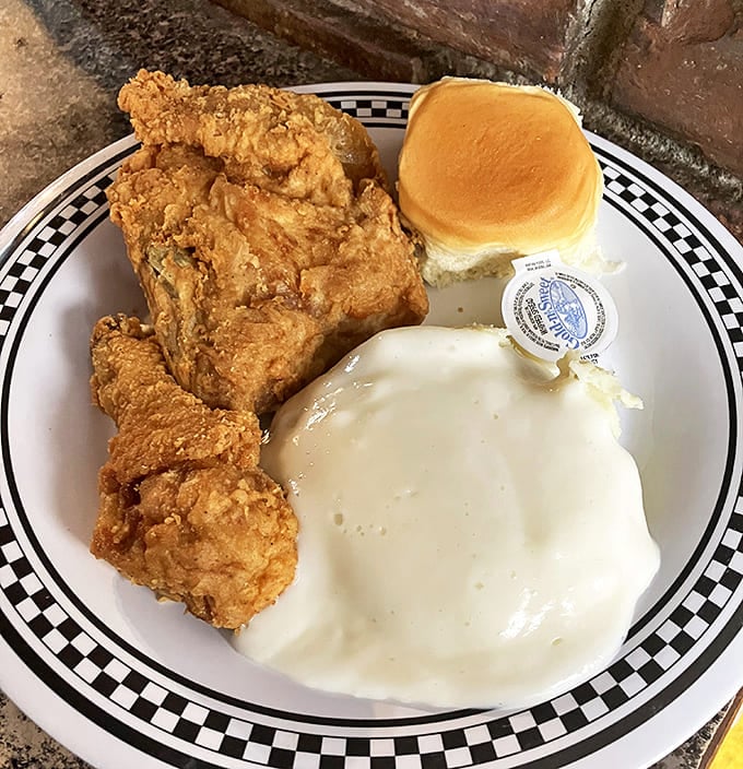 Fried chicken that makes Colonel Sanders look like an amateur, served with mashed potatoes that could solve world peace if properly distributed.