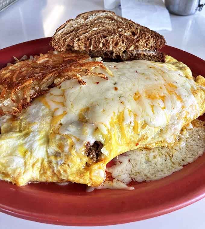 This isn't just an omelet&mdash;it's architecture. Layers of egg, cheese, and fillings creating a savory skyscraper that puts fancy brunch spots to shame.
