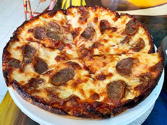 Sausage pizza perfection &ndash; each bite delivers that magical trinity of crispy-edged crust, melted cheese, and savory meat that makes Monday feel like Friday.