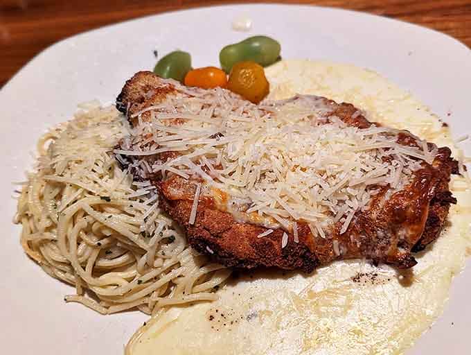 Veal parmigiana that would make any nonna weep with joy, perched atop a pasta throne with enough cheese to satisfy Wisconsin's export quota.
