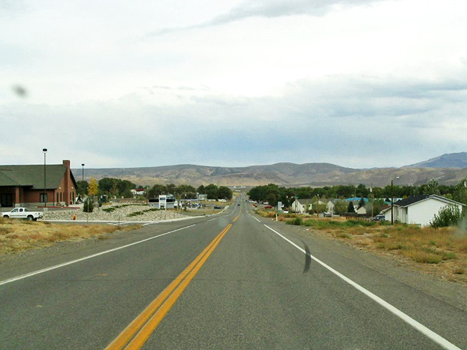 Carlin's wide-open road stretches toward distant mountains, offering a glimpse of the peaceful pace that defines small-town Nevada living.