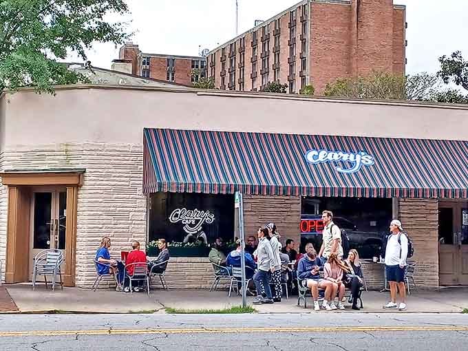 The striped awning of Clary's beckons like an old friend, promising comfort food and conversations that flow as easily as the coffee.