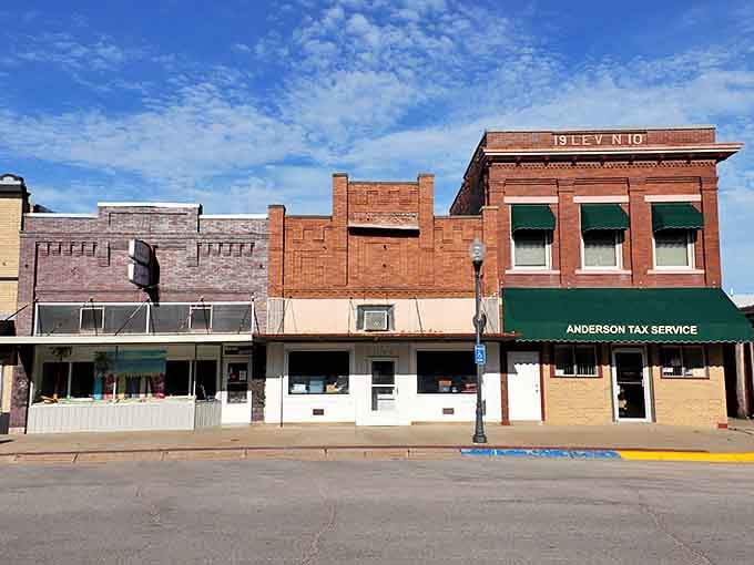 Classic brick storefronts line the street where time moves slower and neighbors still wave from their windows.
