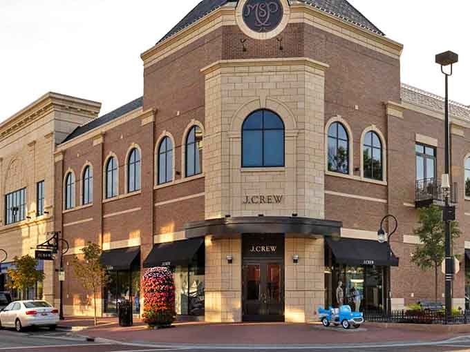 Those arched windows and careful stonework prove shopping districts can have both style and substance without corporate sameness.