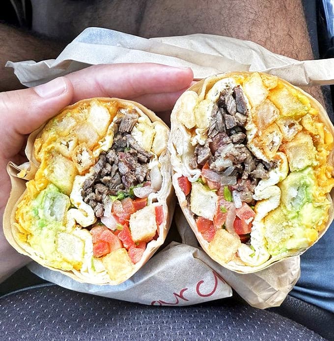 Breakfast burritos packed with eggs, meat, and potatoes &ndash; the kind of portable morning meal that makes hitting the snooze button worth it.