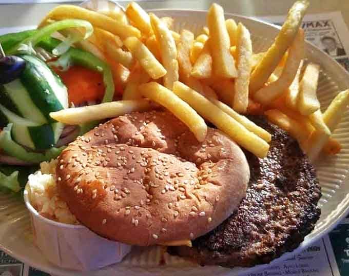 The burger deluxe arrives with fries stacked like golden Lincoln Logs and veggies so fresh they might have been harvested while you ordered.