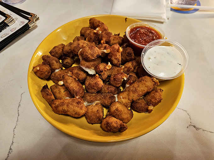 Golden-brown chicken tenders that crunch like autumn leaves, served with dipping sauces worth fighting over.