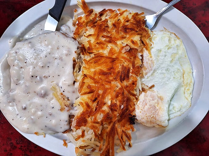 Country gravy cascading over crispy hash browns with a perfectly cooked egg&mdash;comfort food that speaks fluent Alaskan.