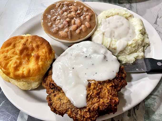 The chicken fried steak—where beef meets breading in a marriage blessed by gravy. That fluffy biscuit isn't just a side; it's the perfect gravy delivery system.